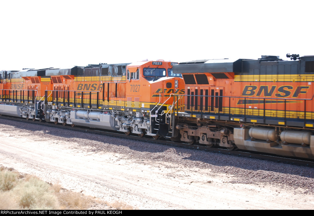 BNSF 7027 and the rear of BNSF 7024 follow the lead unit BNSF 7435 into Barstow for f crewswap